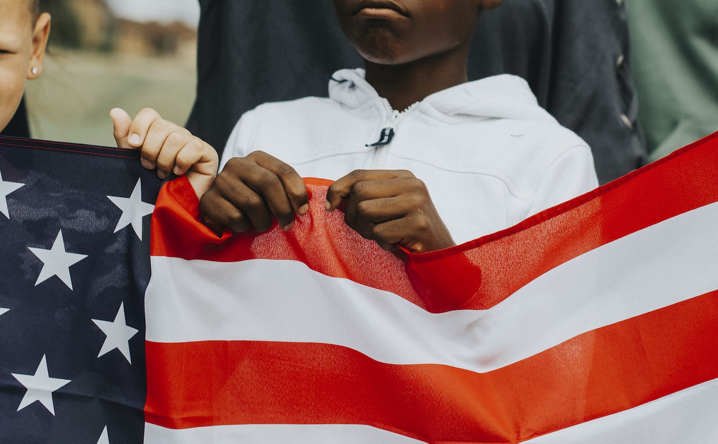 Group of diverse kids showing a US flag in a protest | Paducah ...